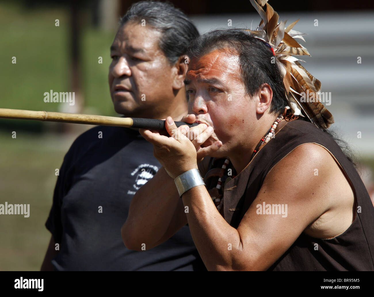 A Cherokee man, member of the Warriors of AniKituhwa group, blows a ...