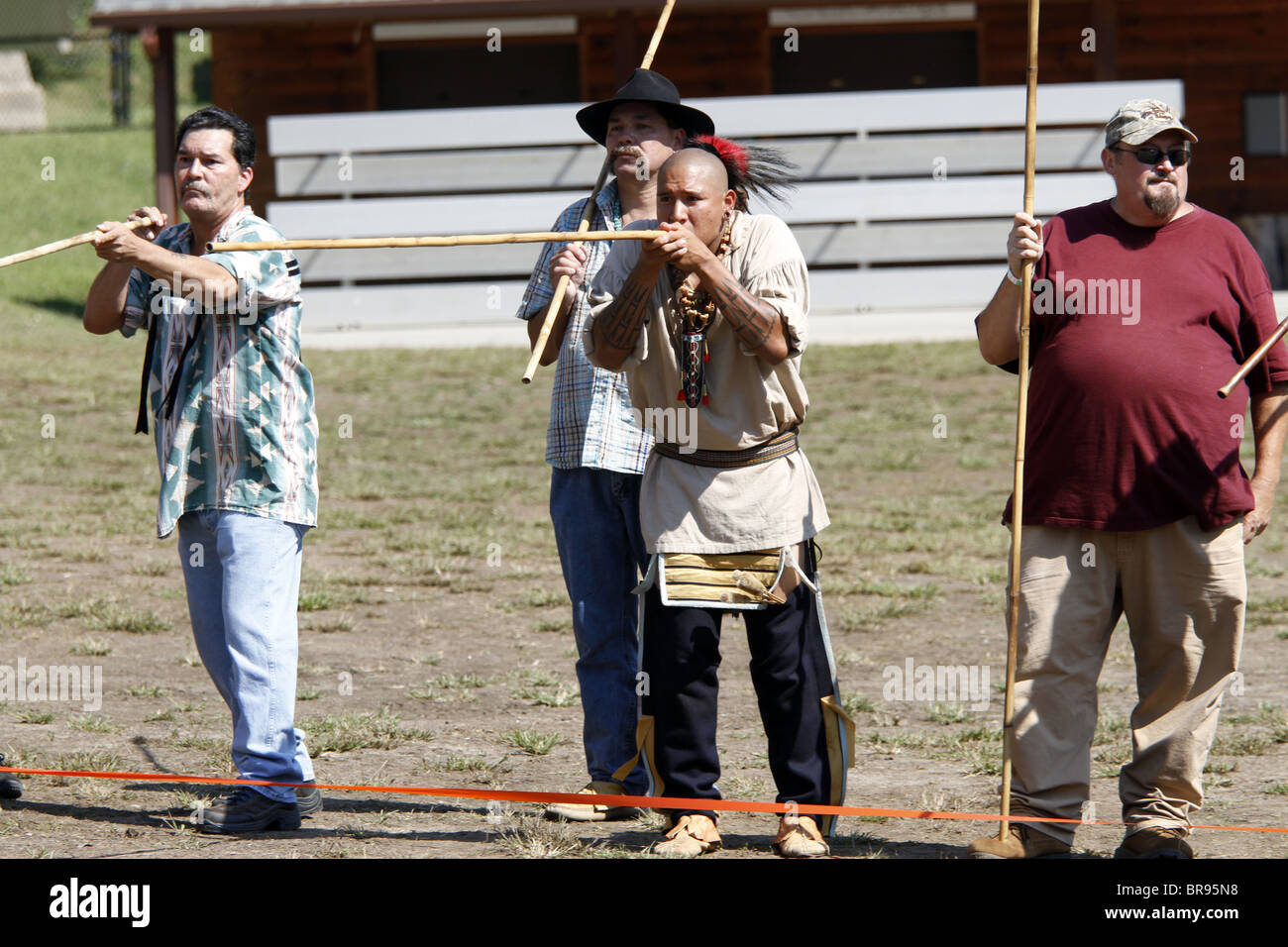 A Cherokee man, member of the Warriors of AniKituhwa group, blows a ...