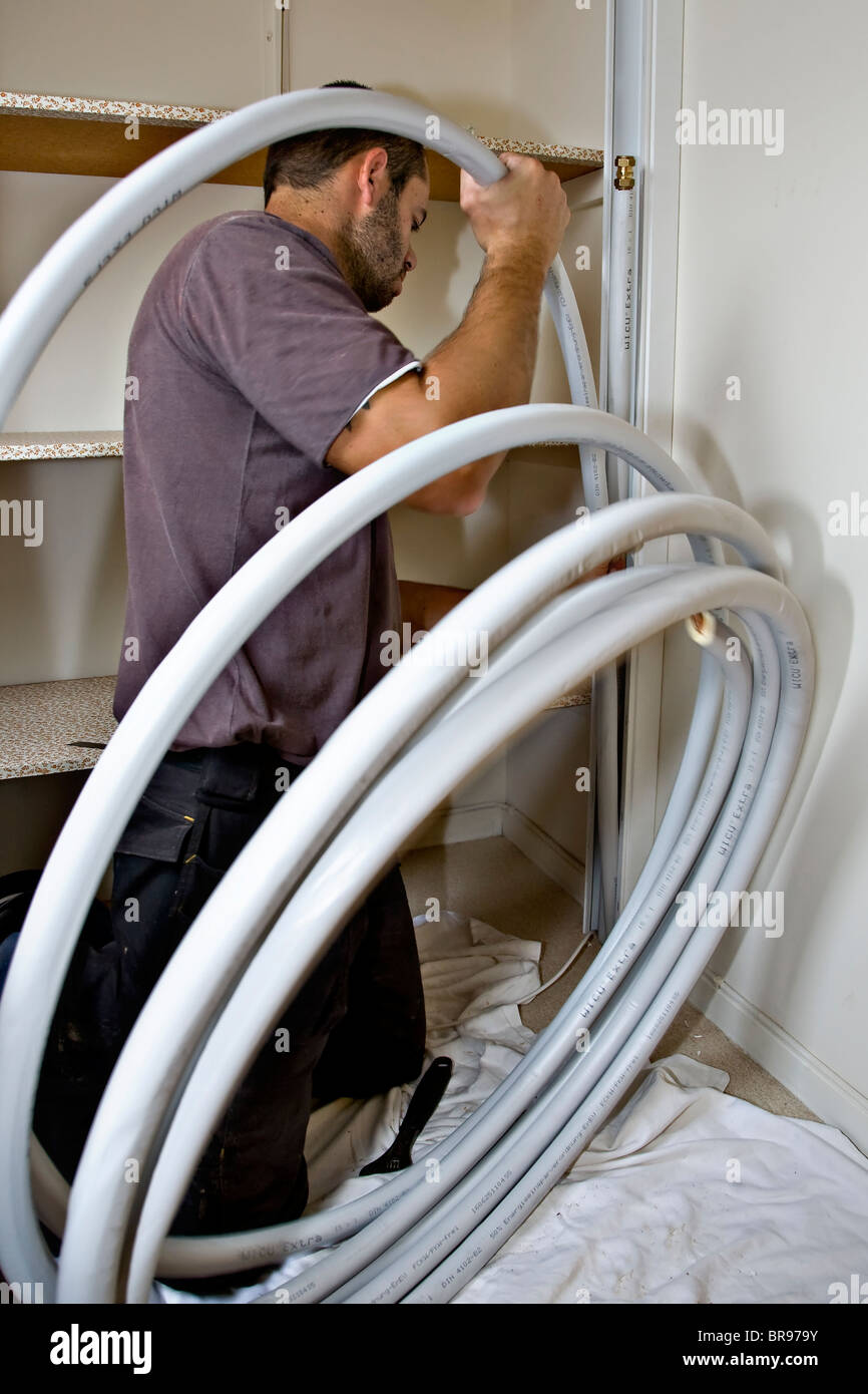 Plumber connecting pipes Stock Photo - Alamy