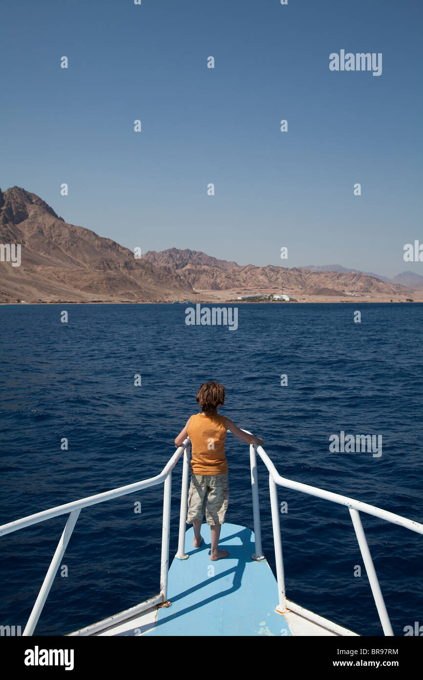 A young boy on the bow of a boat, Dahab, Egypt Stock Photo - Alamy