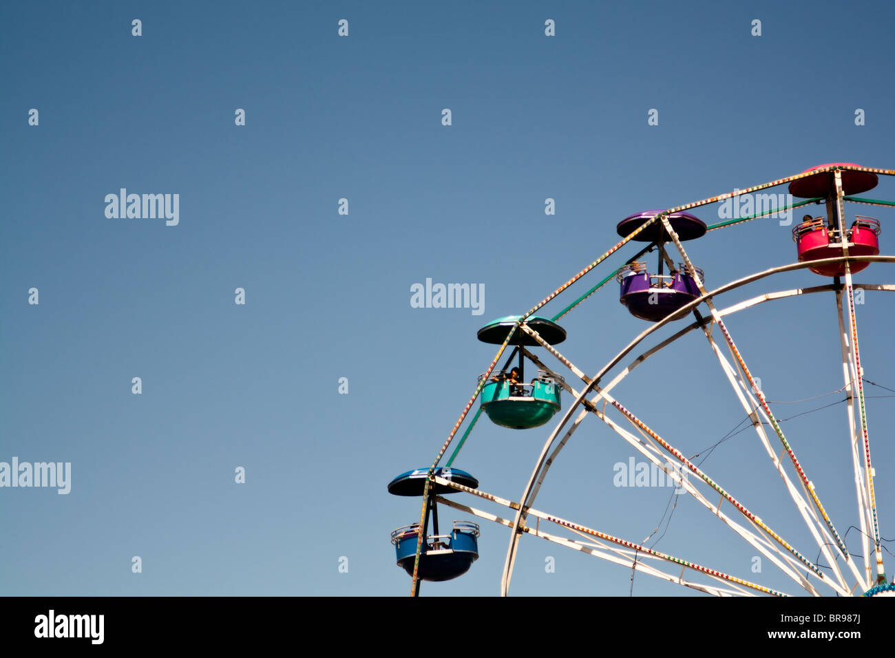 A partial image of a ferris wheel set against blue sky Stock Photo - Alamy