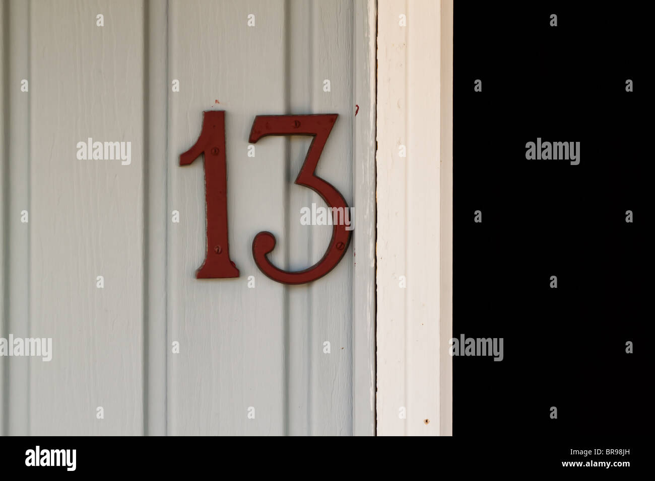 The number 13 on a wall by a doorway Stock Photo - Alamy