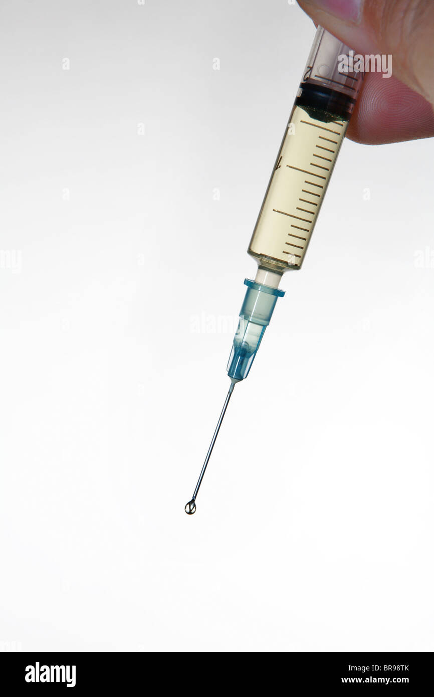 close up detail image of a mans hand holding a syringe Stock Photo - Alamy