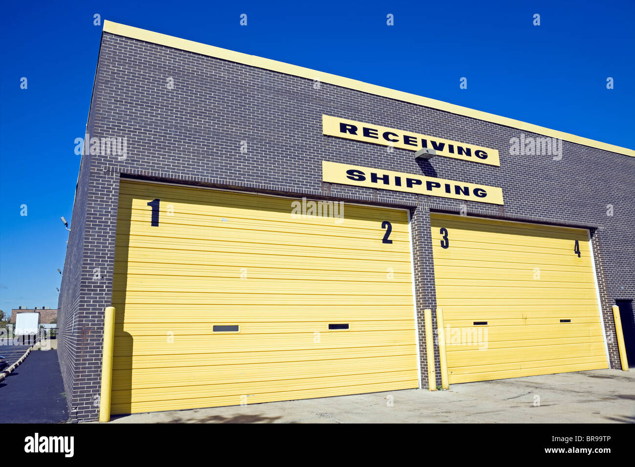 Warehouse with yellow gates Stock Photo - Alamy