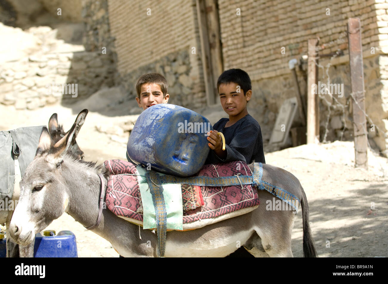 Boys with donkey hauling water up to their village in Kabul ...