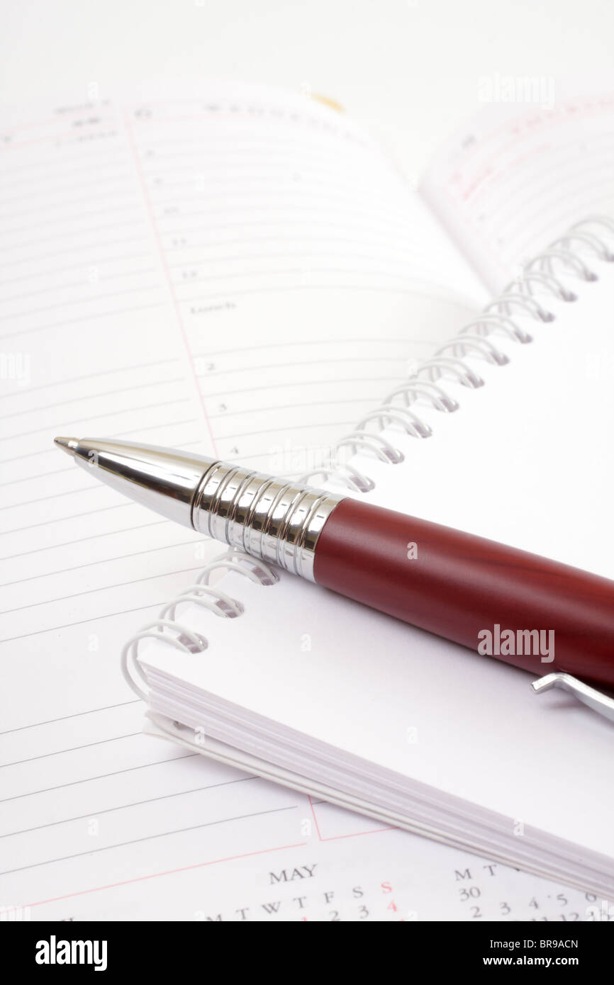 pen at office on a daily organizer Stock Photo - Alamy