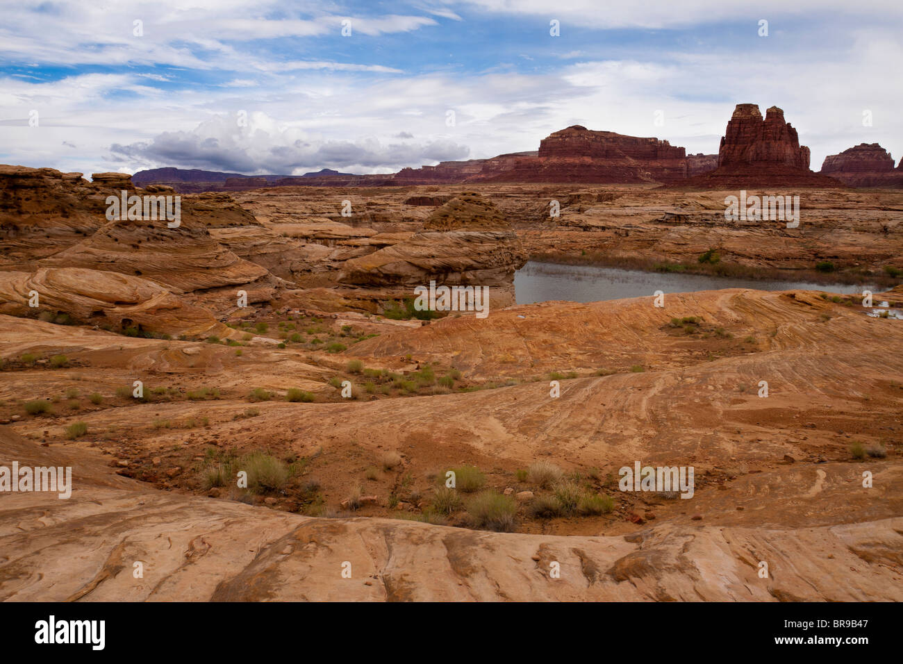 Dramatic swirling orange rock formations and red buttes at the head of ...