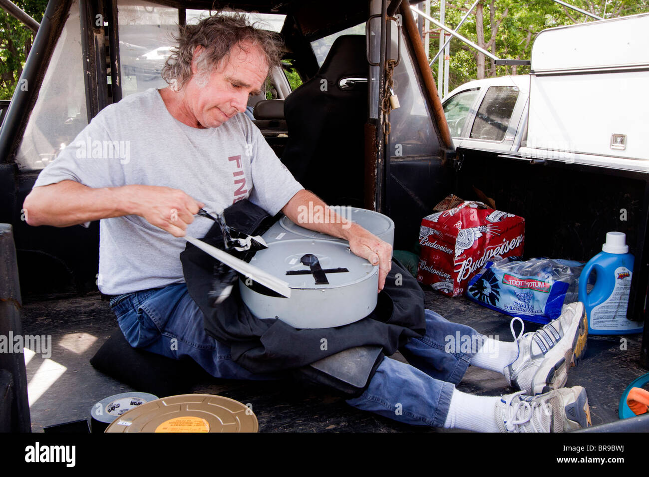 IMAX film maker Jack Tankard removes tape from an IMAX film canister in ...
