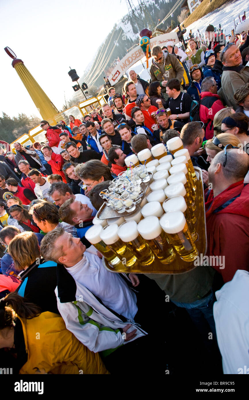 A waiter carries thirty nine and half liters of beer and a tray of ...