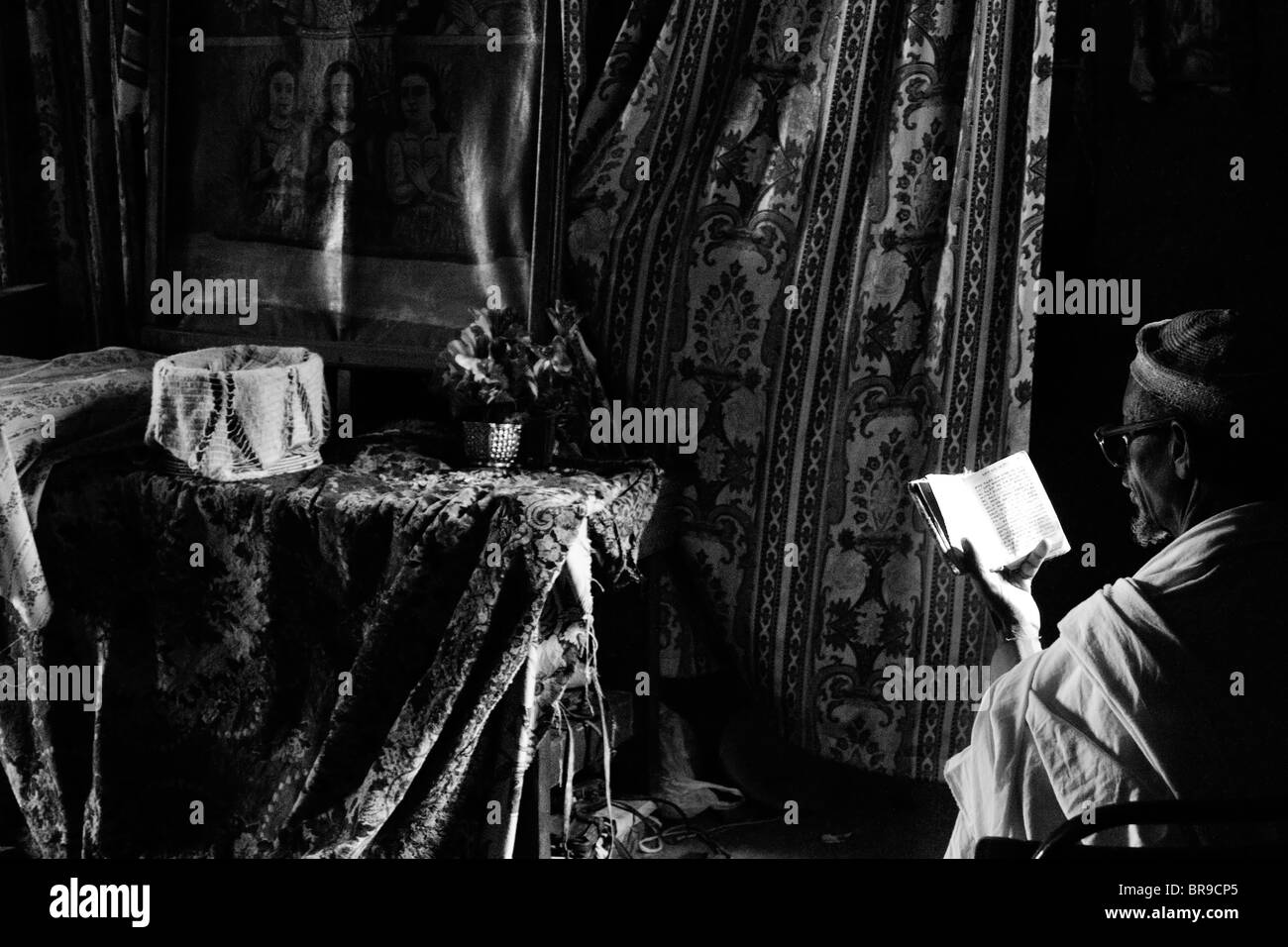 Old priest reading the Bible in one of the churches of Lalibela ...