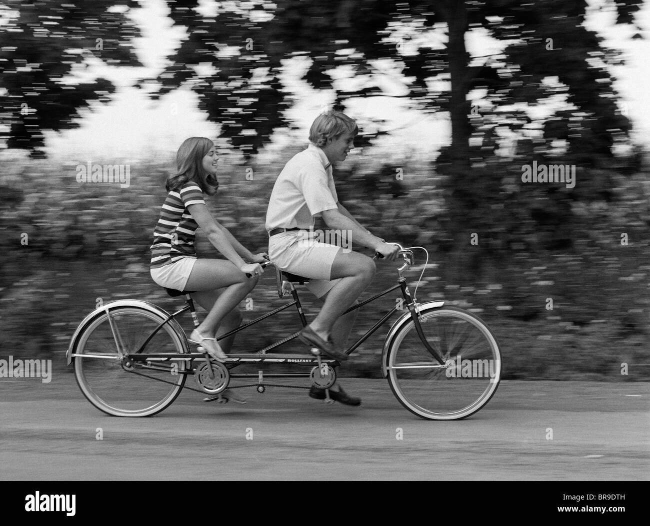 1970s TEENAGE GIRL AND BOY RIDING BICYCLE BUILT FOR TWO Stock Photo - Alamy