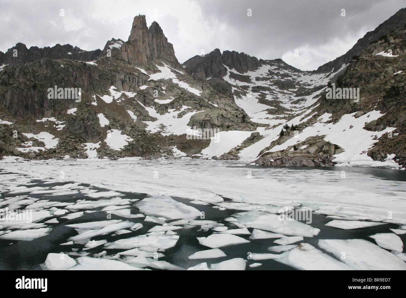 Agulles D'Amitges mountain lake melting ice cirque on Traverse track ...
