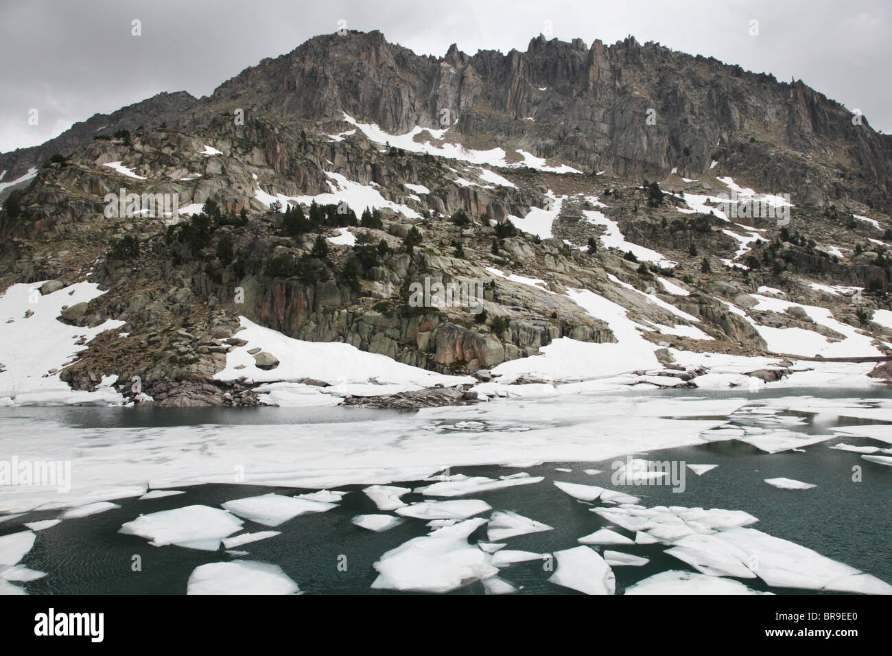 Agulles D'Amitges mountain lake melting ice cirque on Traverse track ...