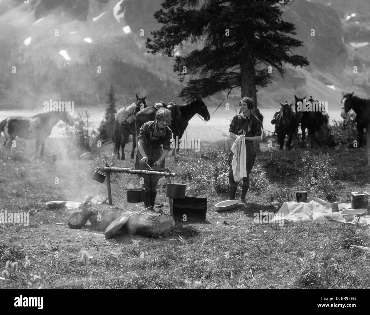 Woman cooking over fire Black and White Stock Photos & Images - Alamy