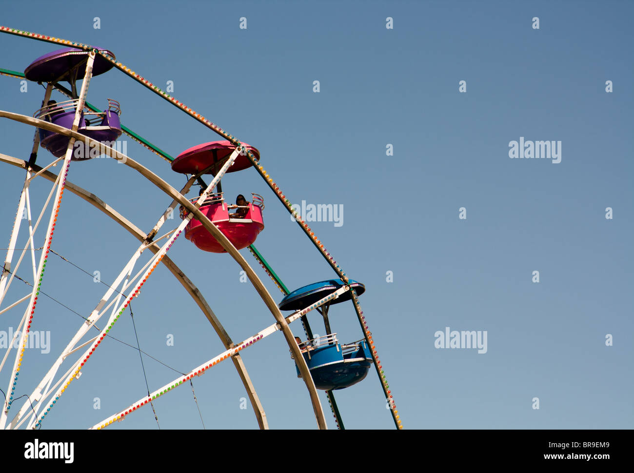 A partial image of a ferris wheel set against blue sky Stock Photo - Alamy