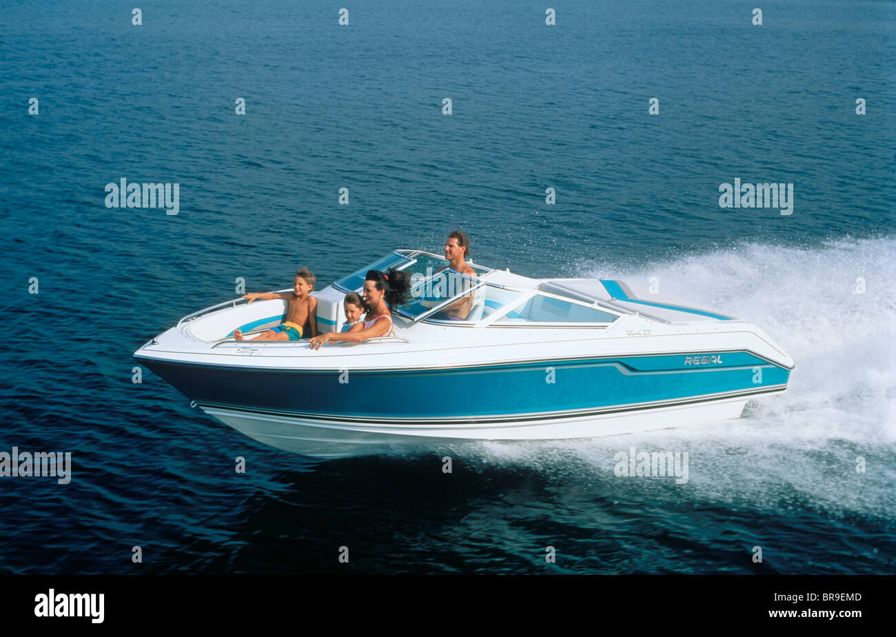 1990s FAMILY IN MOTOR BOAT SPEEDING OVER WATER MOTHER FATHER 2 KIDS ...