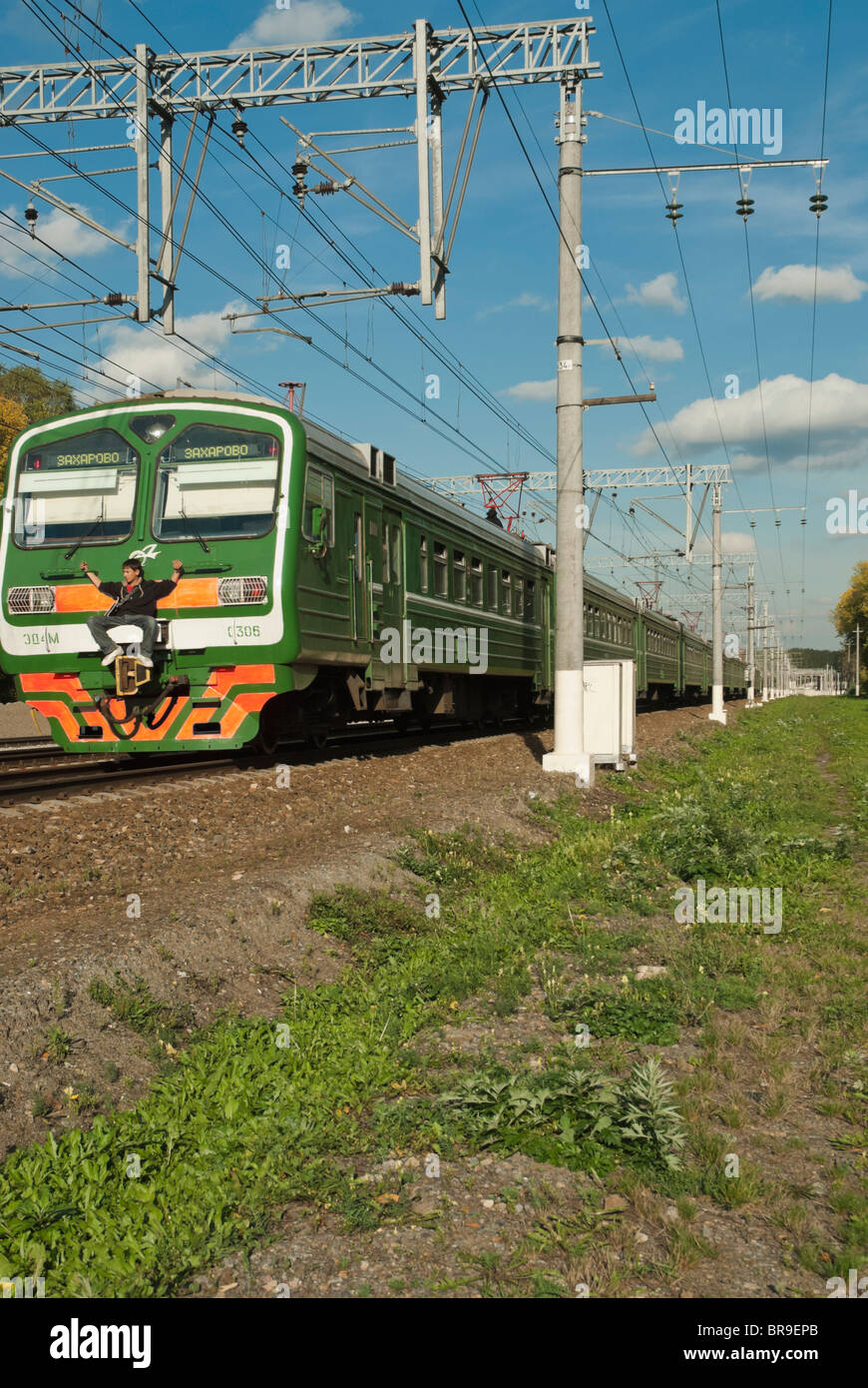 Russian electric train with free rider passenger Stock Photo - Alamy