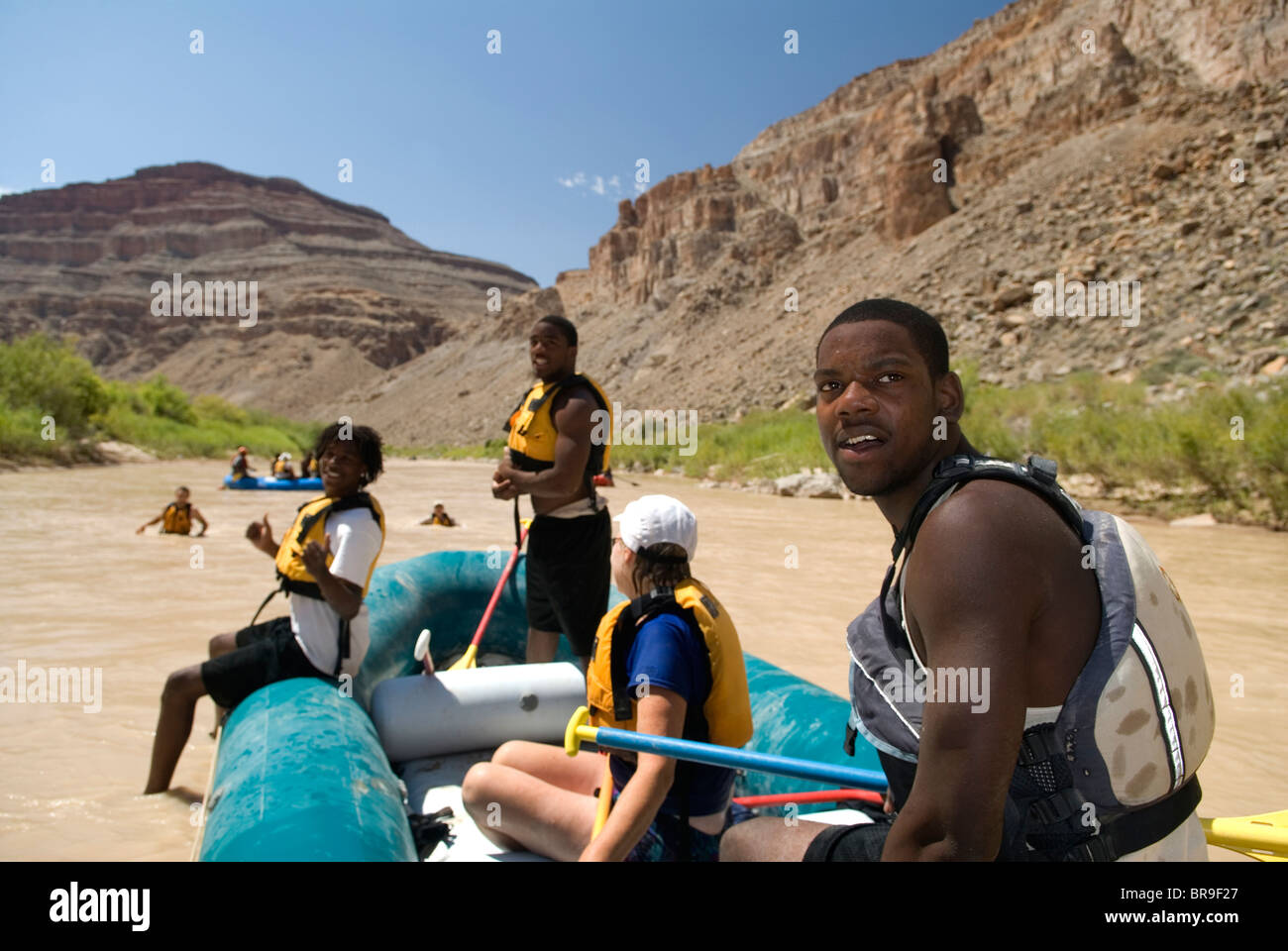 A group of kids take a break while on a rafting expedition on the ...