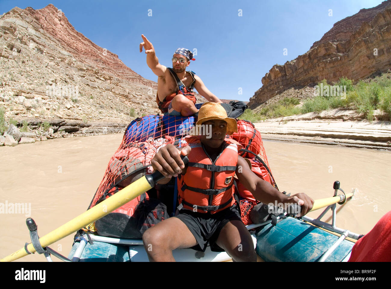 A teenager steers a boat while rafting with a guide down the Dolores ...