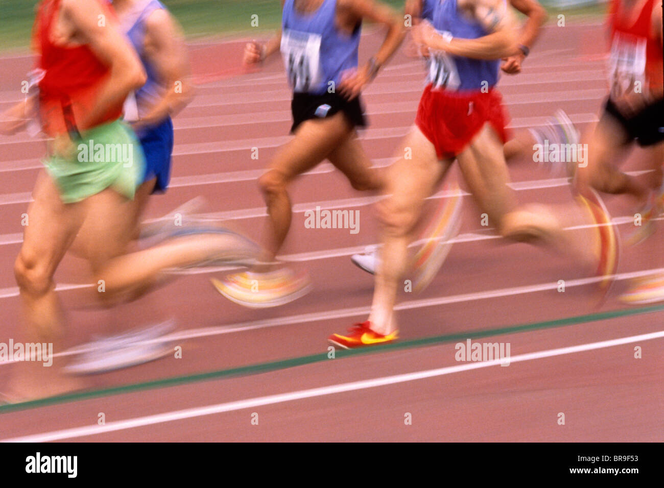 BLURRED MOTION FEET AND LEGS OF MEN RUNNING A RACE ON A TRACK Stock ...