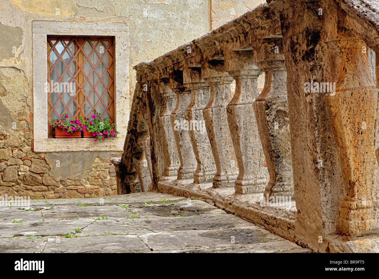 Medieval stone railing and window, Monteriggioni, in the Province of ...