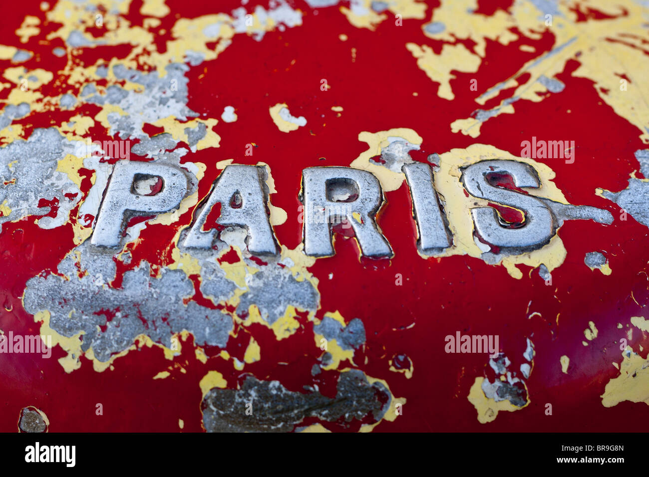 The word Paris is embossed in metal with flaking paint Stock Photo - Alamy