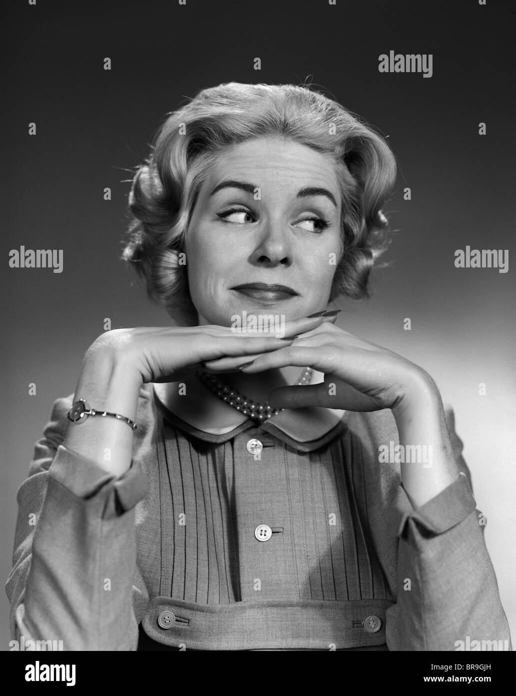 1960s SMILING BLONDE WOMAN RESTING CHIN ON HANDS LOOKING LEFT Stock ...