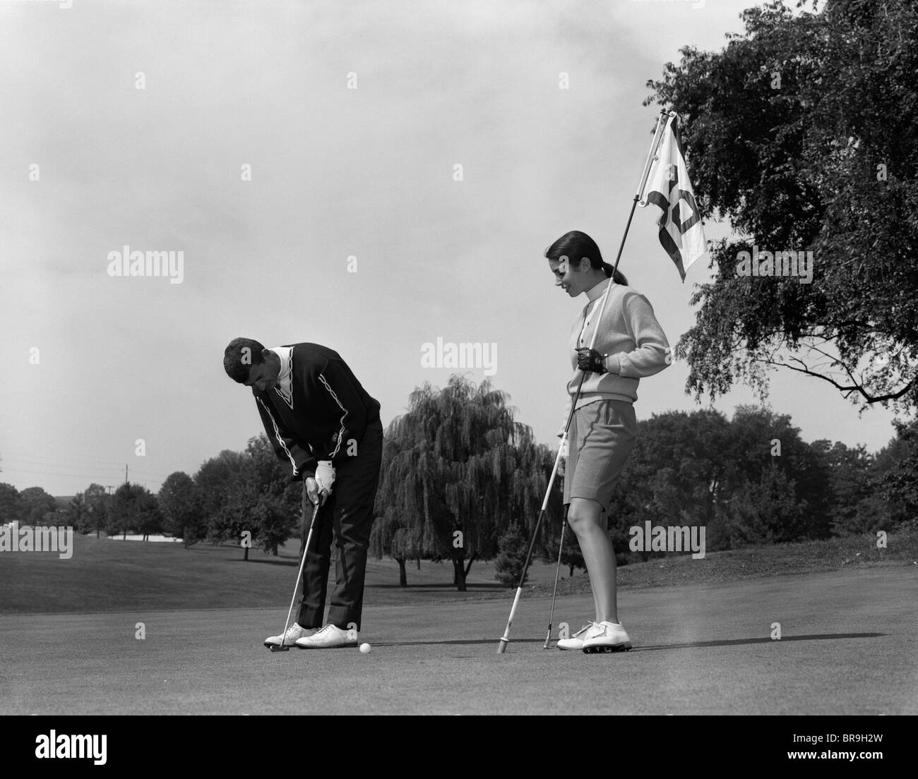 Walking man woman holding Black and White Stock Photos & Images - Alamy