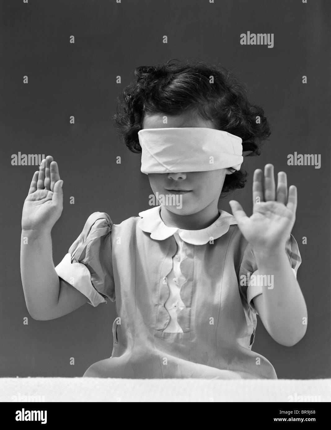 1940s CHILD WEARING BLIND FOLD WITH HANDS UP IN THE AIR Stock Photo - Alamy