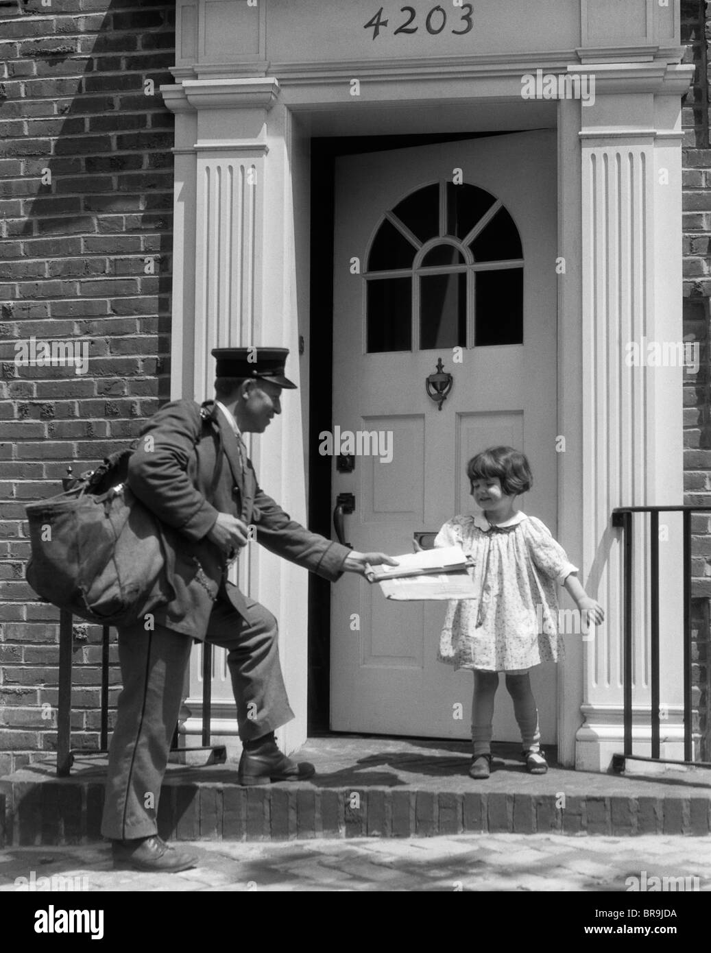 1920s SMILING LITTLE GIRL RECEIVING MAIL FROM POSTMAN Stock Photo - Alamy