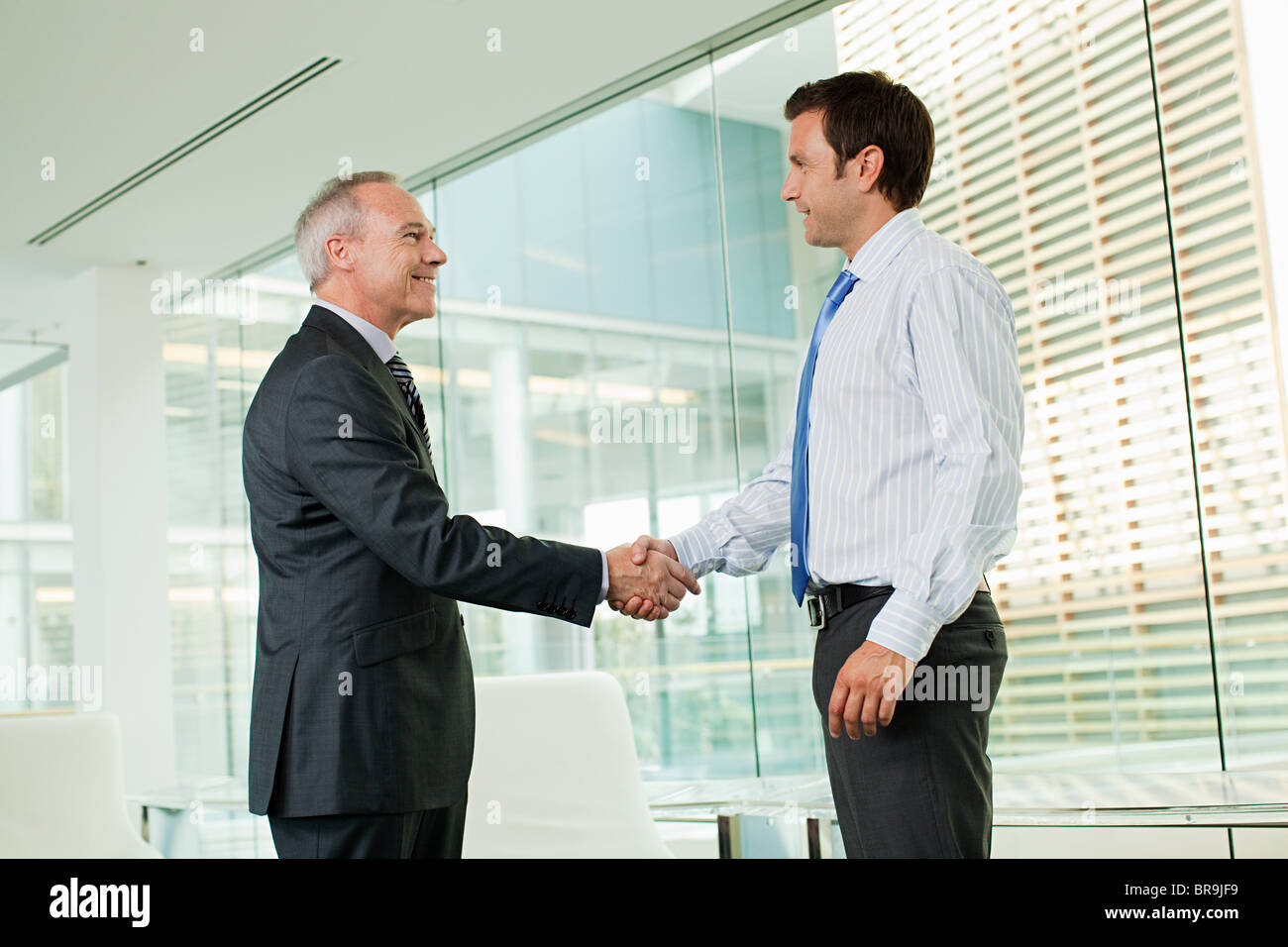 Businessmen shaking hands Stock Photo - Alamy
