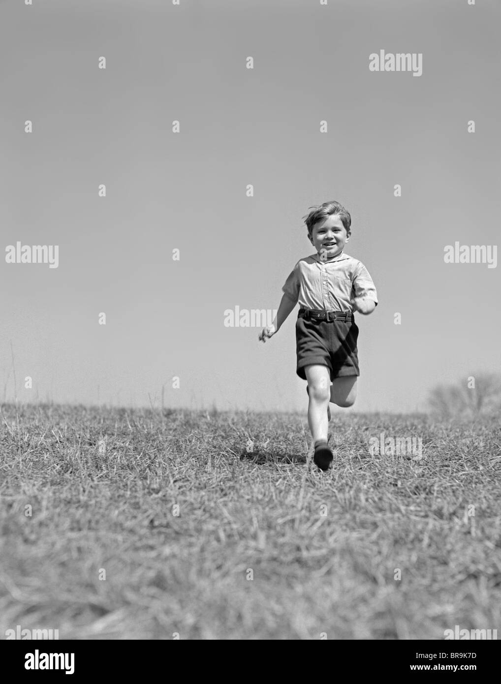 Children running through field Black and White Stock Photos & Images ...