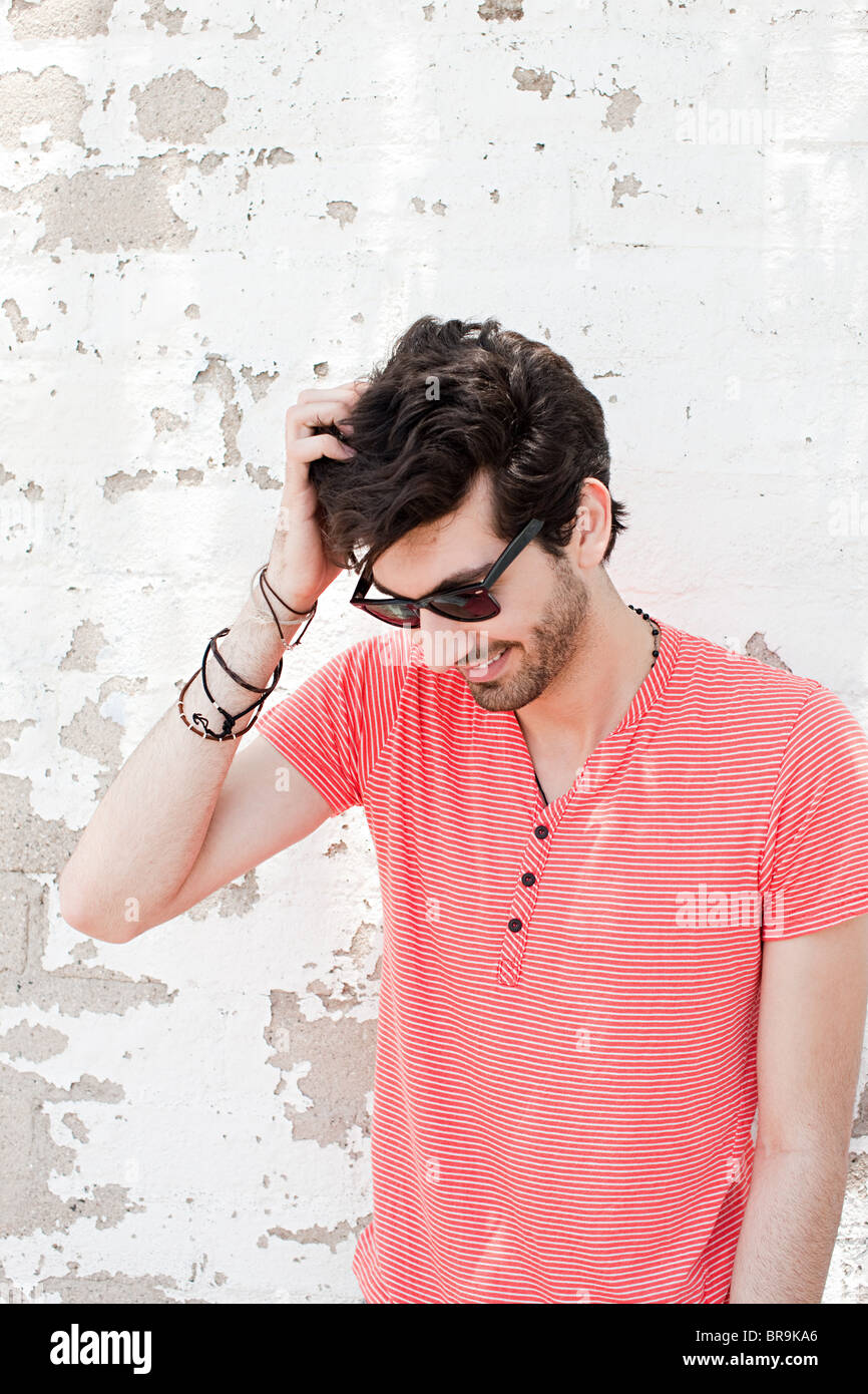 Young man scratching head Stock Photo - Alamy