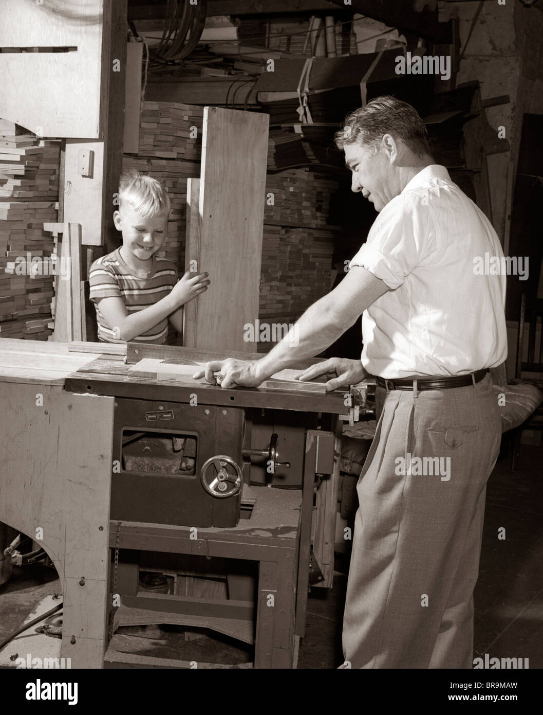 1930s 1940s 1950s MAN FATHER CUTTING WOOD BOARD ON TABLE SAW TEACHING ...