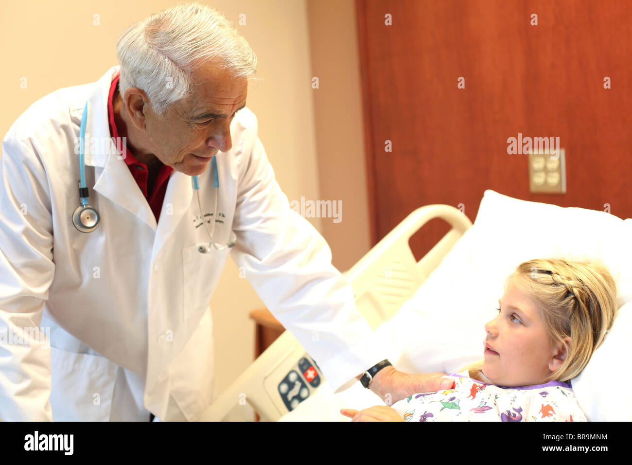 Doctor leaning over hospital bed hi-res stock photography and images ...