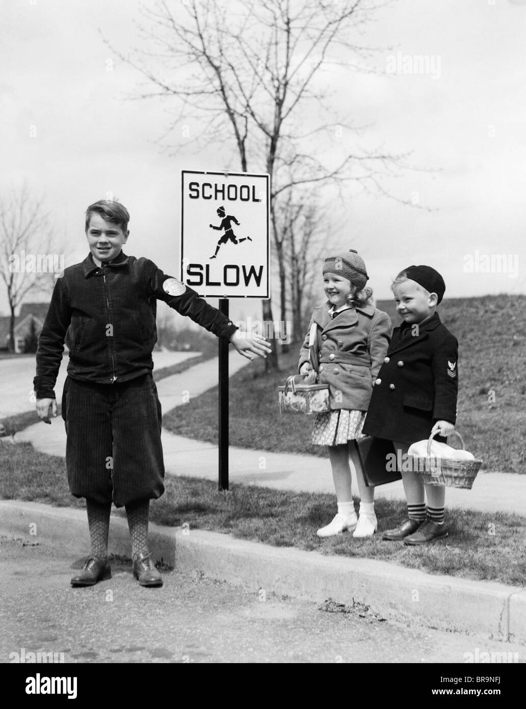 Children waiting to cross street Black and White Stock Photos & Images ...