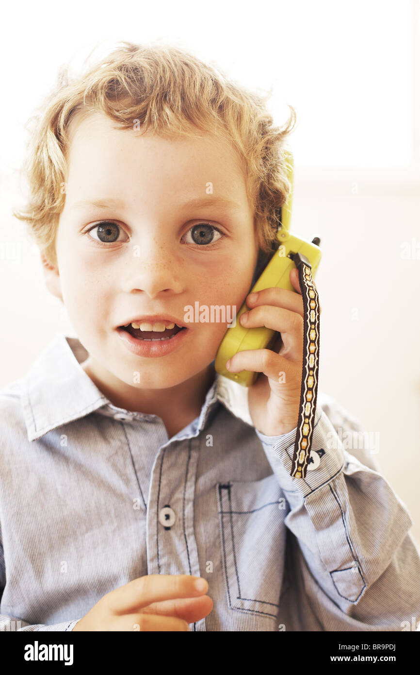 Young boy talking on a pretend cell phone Stock Photo - Alamy