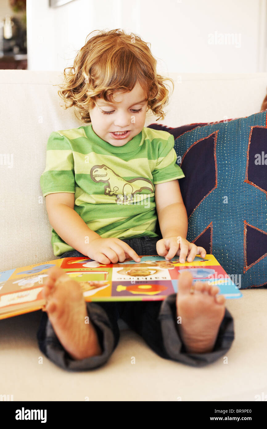 Little boy reading a book Stock Photo - Alamy