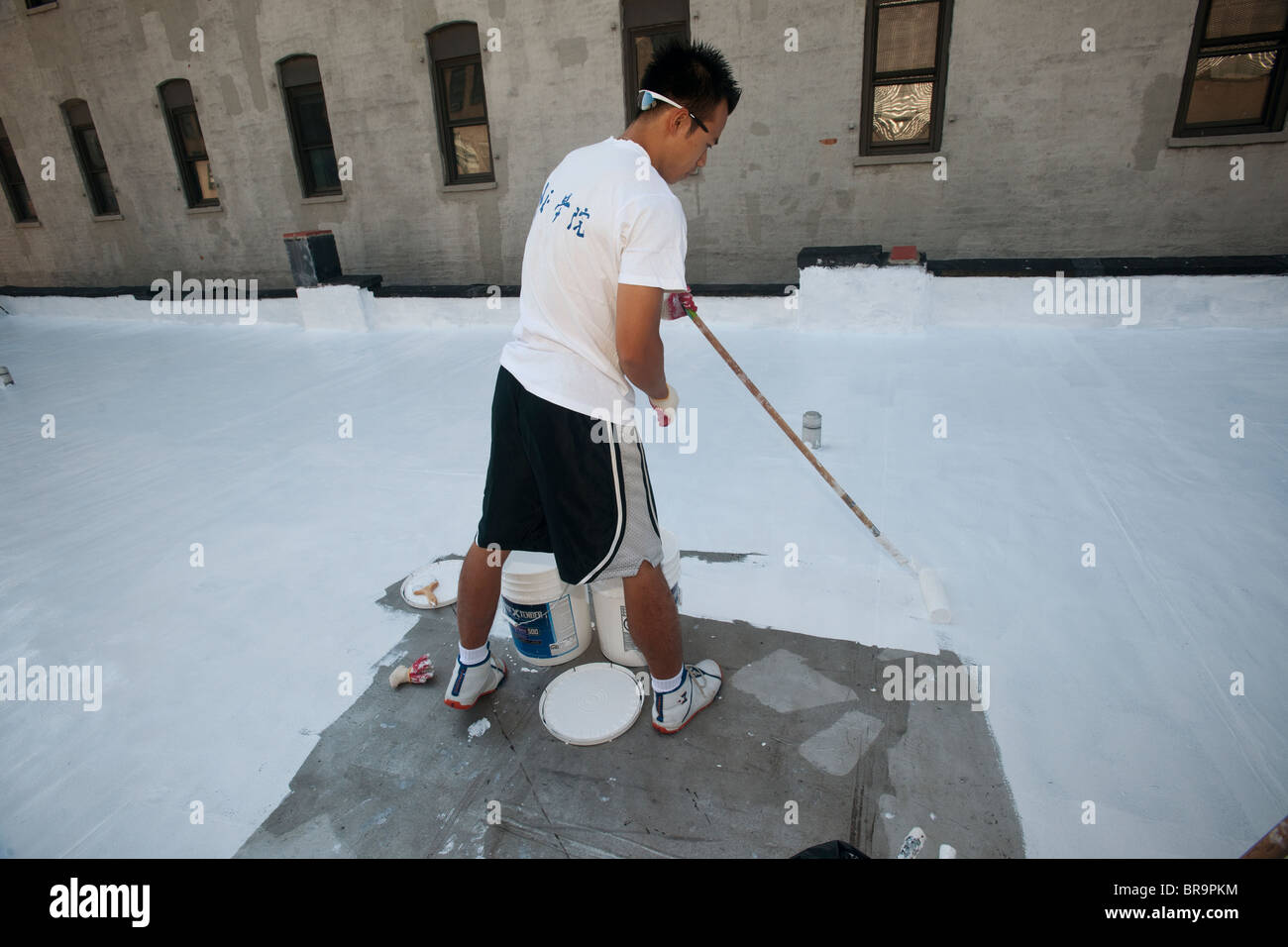 Volunteers paint the the roof of the Bowery Mission in New York with ...