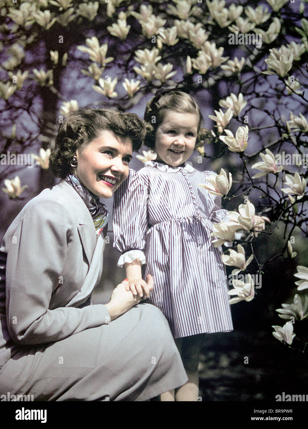 1940s WOMAN MOTHER GIRL DAUGHTER SMILING BY MAGNOLIA BLOSSOMS TULIP ...