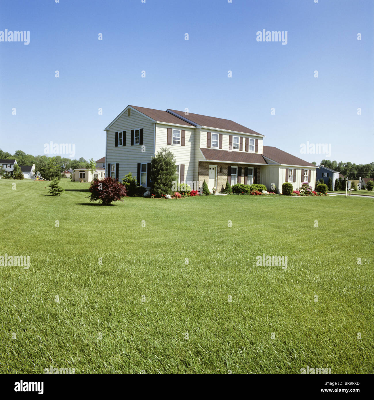 1980s SUBURBAN TWO STORY HOUSE WITH LARGE FRONT LAWN AND SHRUBBERY ...