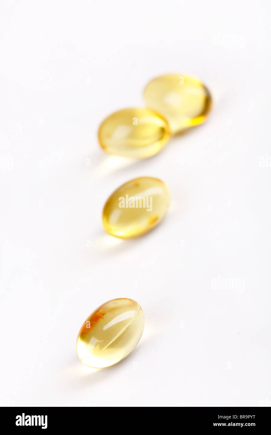 Yellow vitamin fish oil capsule Cut Out Stock Images & Pictures - Alamy