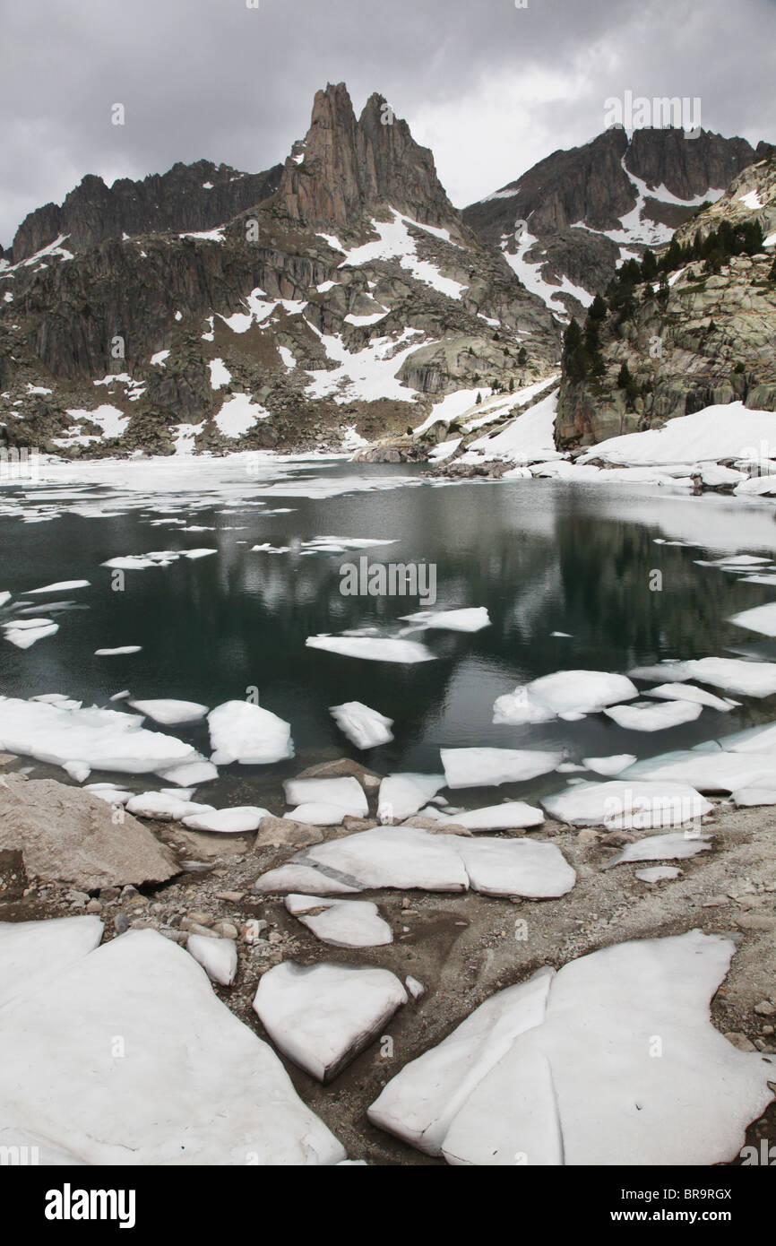 Agulles D'Amitges mountain lake melting ice cirque on Traverse track ...