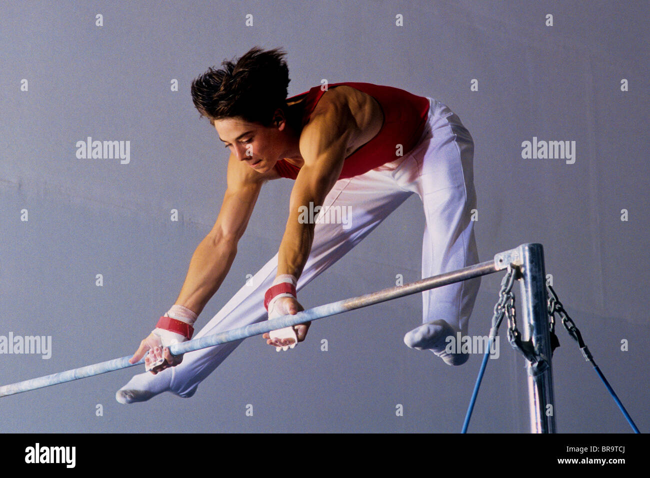 Male gymnast performing on the horizontal bar Stock Photo - Alamy
