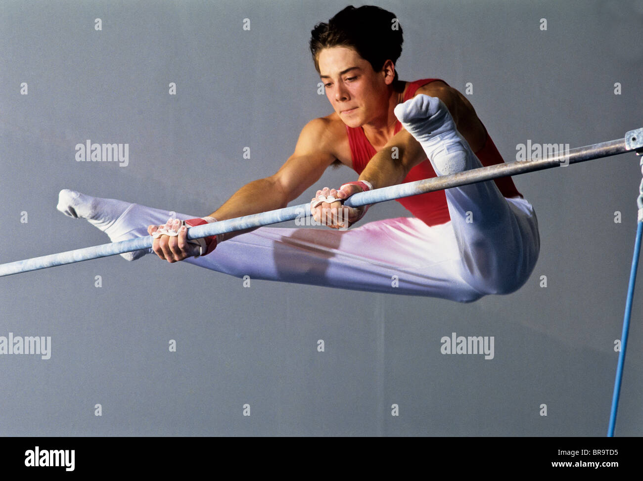Male gymnast performing on the horizontal bar Stock Photo - Alamy