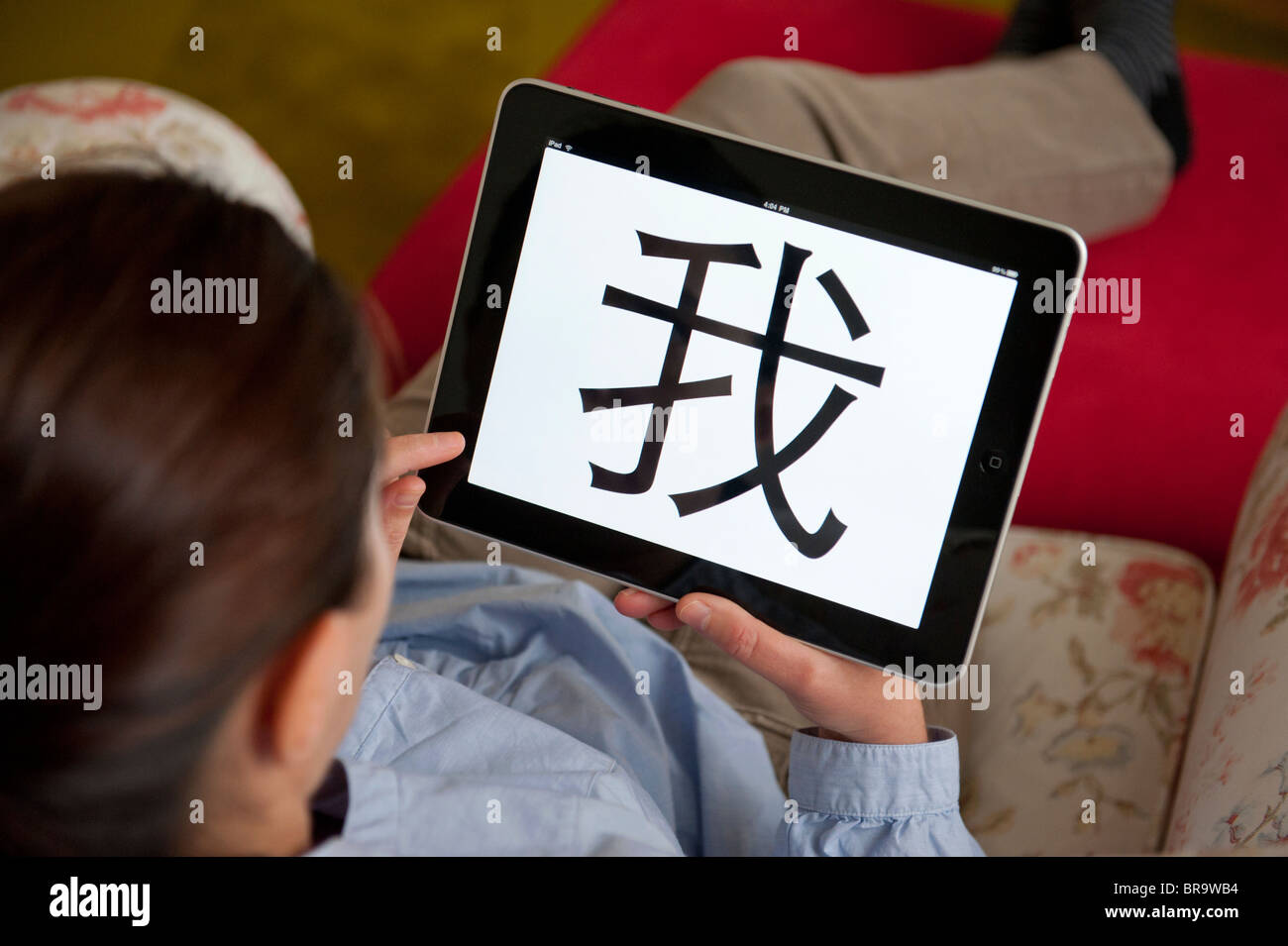 Female student learning mandarin Chinese using education application on ...