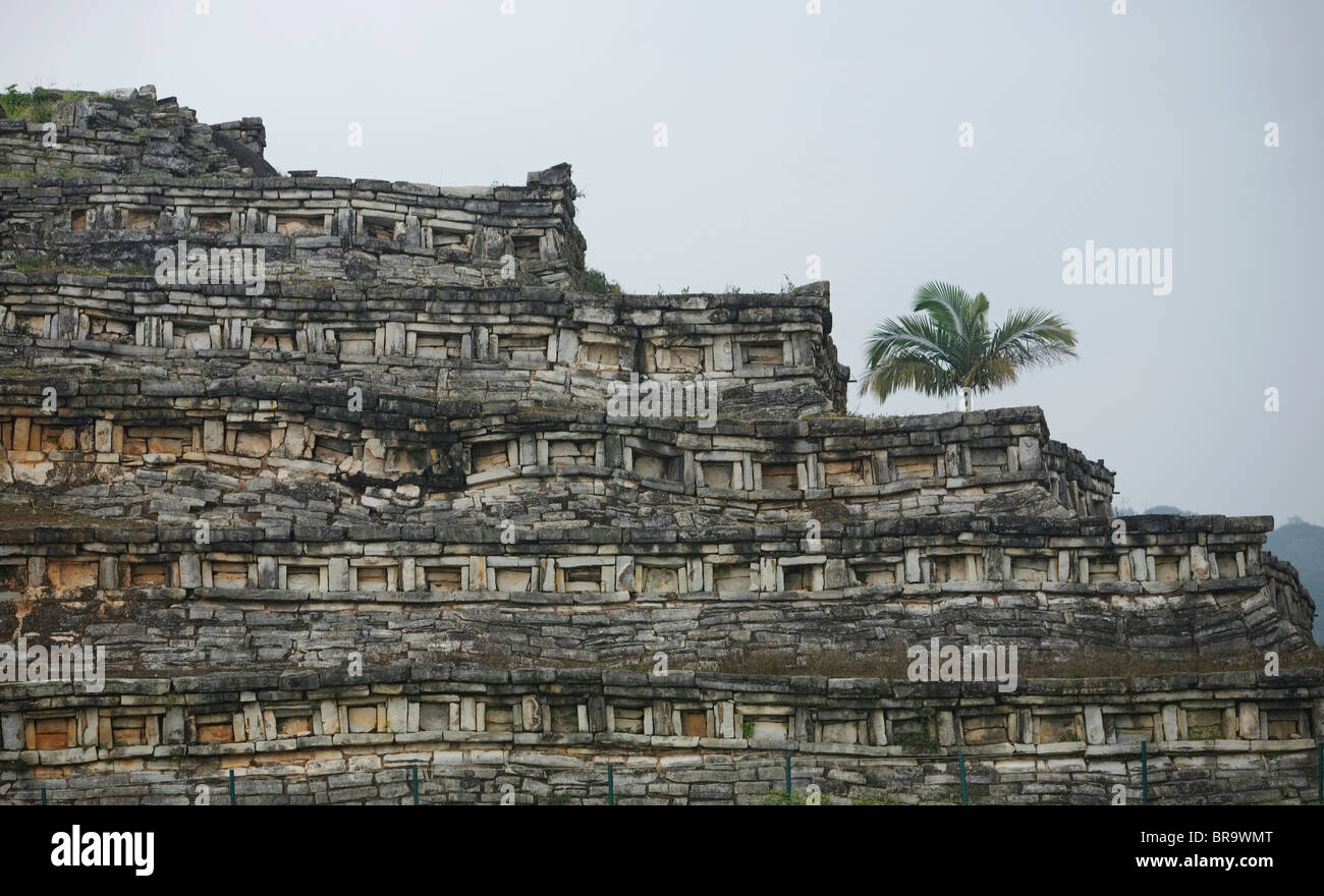 A palm tree peeks over a pyramid of the Totonacan ruins in Yohualichan ...