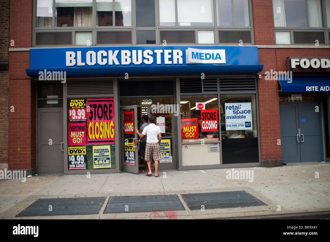Store closing signs posted in the window of a Blockbuster Media store ...