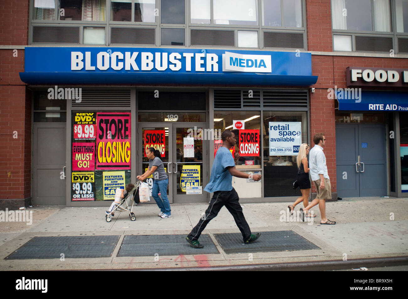Store closing signs posted in the window of a Blockbuster Media store ...