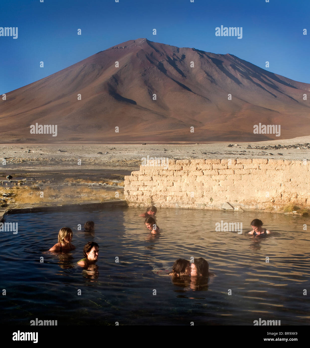 Tourists enjoy a warm hot spring on a tour of Bolivia's Salar de Uyuni ...